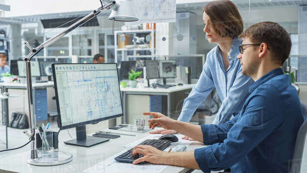 Engineer Talking With Project Manager and Working on Desktop Computer ...