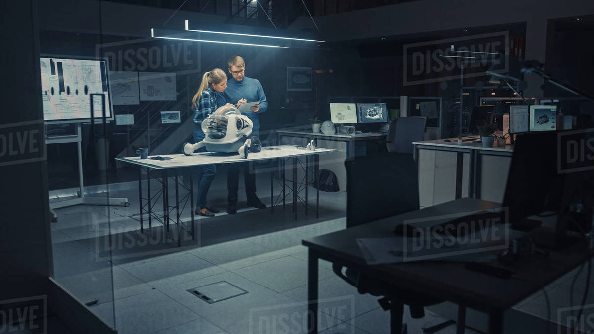 Late at Night in Robotics Engineering Facility Two Technical Engineers ...