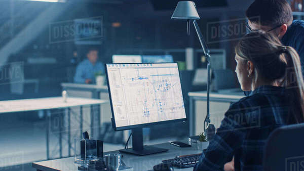 Engineer Working on Desktop Computer, Screen Showing CAD Software with ...