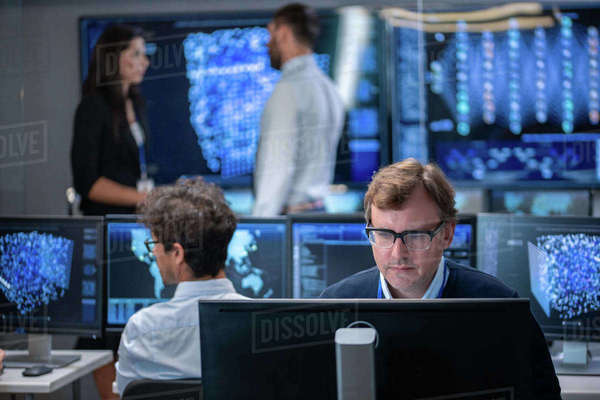 Neural Network Algorithm Architect Working at His Workstation in a Busy ...