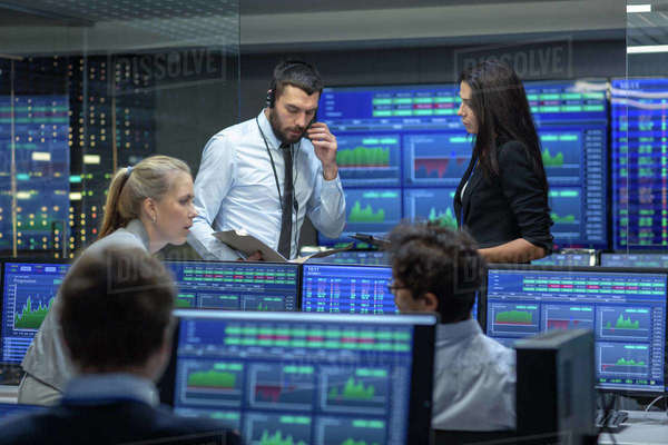 Multi-Ethnic Team of Traders is Busy Working at the Stock Exchange ...