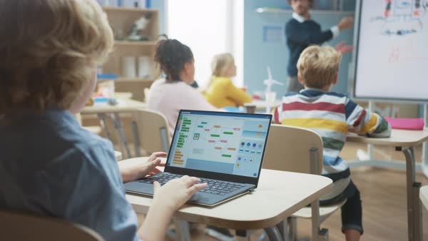 Elementary School Science Class: Over the Shoulder Little Boy Uses ...
