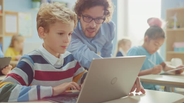 Elementary School Computer Science Class: Smart Boy Uses Laptop ...