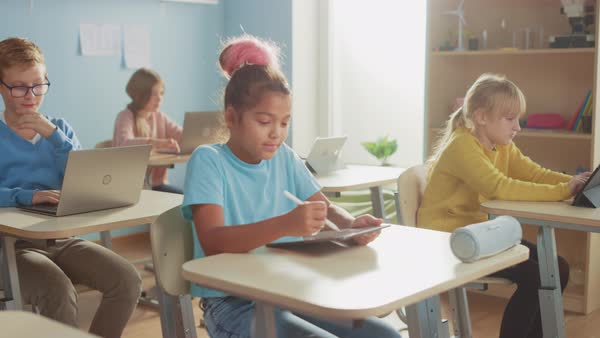Elementary School Computer Science Class: Cute Girl Uses Digital Tablet ...