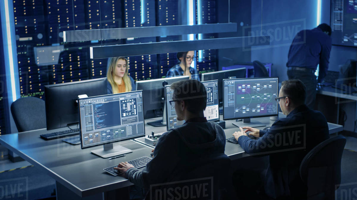 Team of IT Programers Working on Desktop Computers in Data Center System Control Room. Team of ...