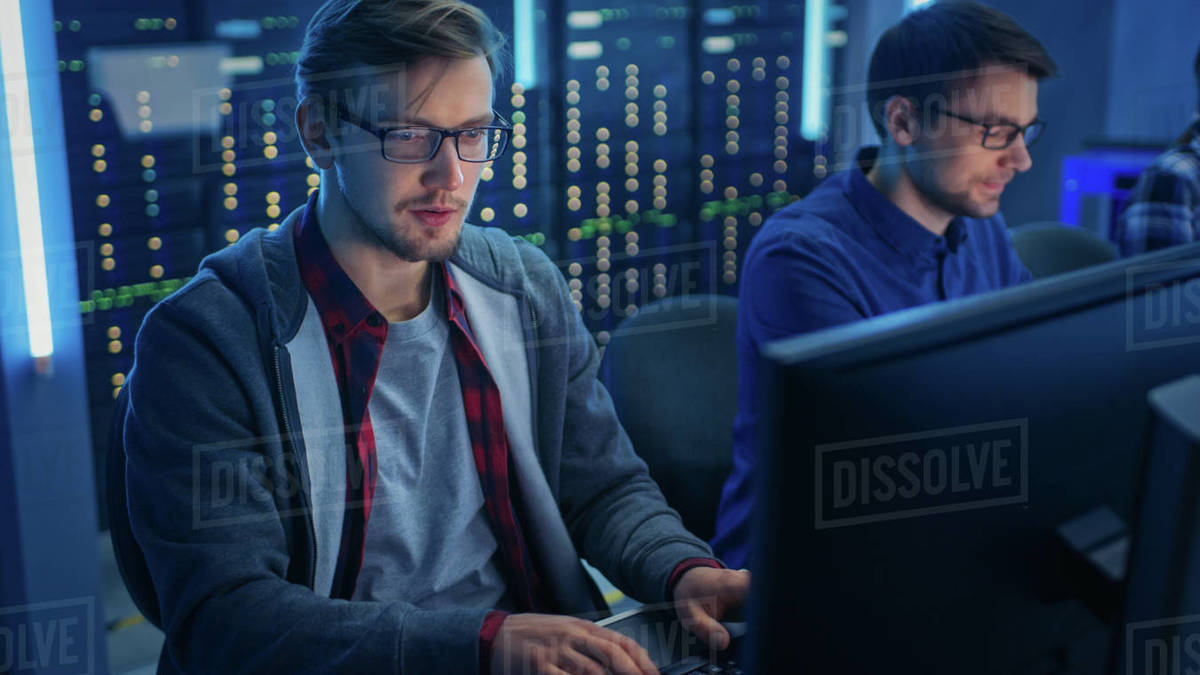 Team of Young IT Programers Working on Desktop Computers in Data Center ...