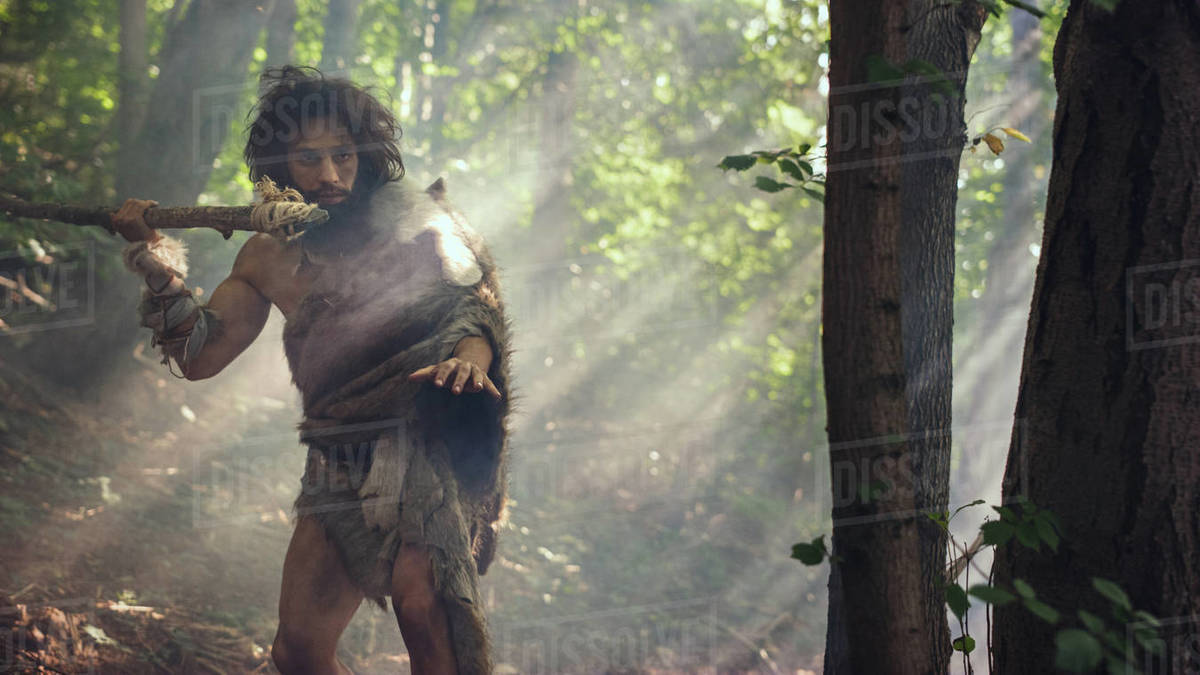 Portrait of Primeval Caveman Wearing Animal Skin and Fur Hunting with a ...