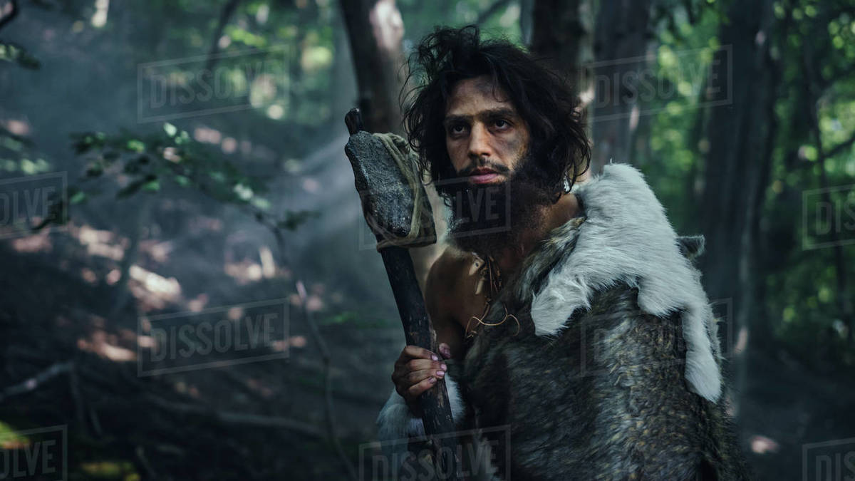 Portrait of Primeval Caveman Wearing Animal Skin and Fur Hunting with a ...