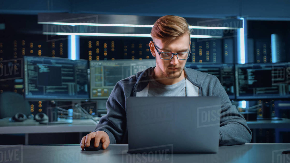 Portrait of Software Developer / Hacker Wearing Glasses Sitting at His ...