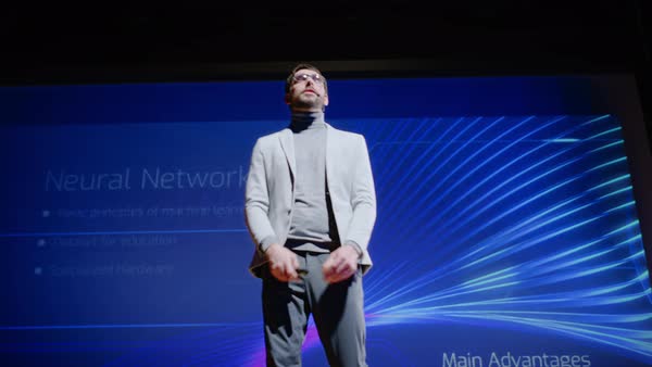 On-Stage Speaker Greets Audience, Presentation of Technological Device ...