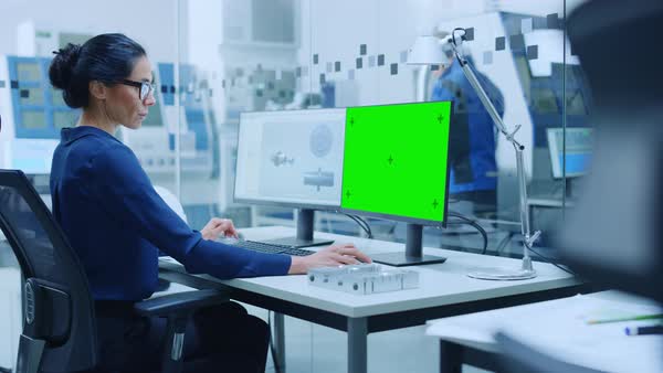 Female Engineer Working on a Personal Computer, Two Monitor Screens ...