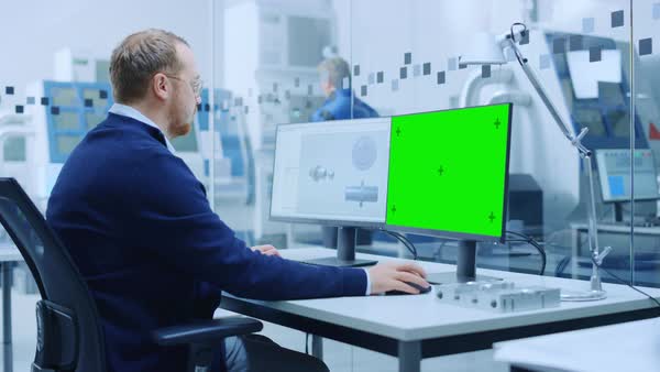 Male Engineer Working on a Personal Computer, Two Monitor Screens Show ...