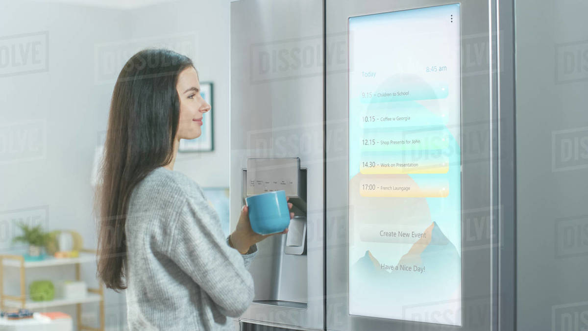 Beautiful Young Girl Stands Next to a Refrigerator While Drinking Her ...