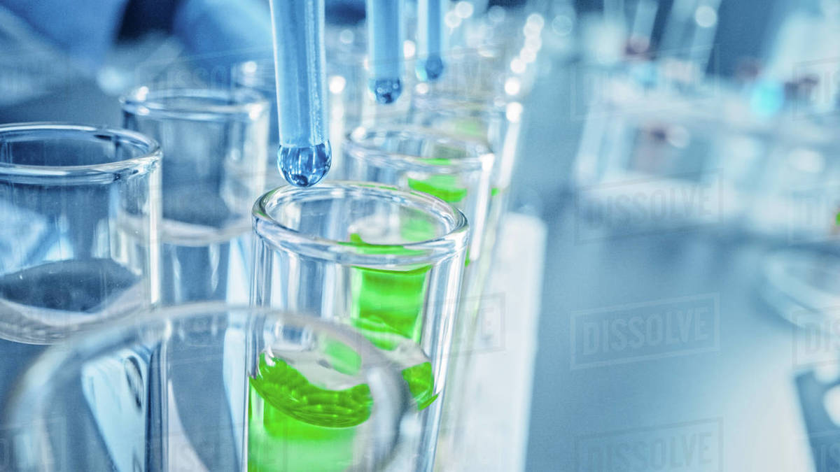 Pharmaceutics Laboratory: Multiple Pipettes Dropping Blue Liquid into ...