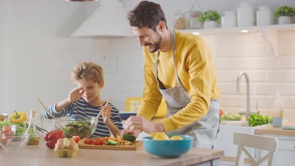 In Kitchen: Father and Cute Little Boy Cooking Together Healthy Dinner ...