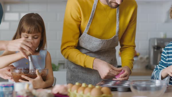 In the Kitchen: Portrait of the Cute Little Daughter Mixing Flour and ...