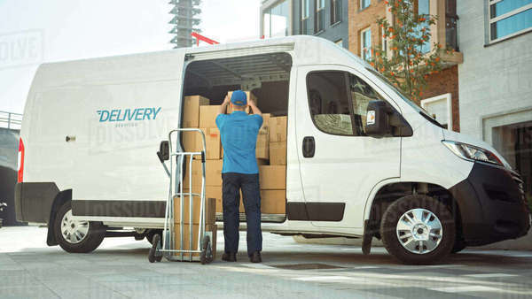 Delivery Man Uses Hand Truck Trolley Full of Cardboard Boxes and ...