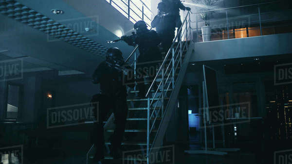 Masked Squad of Armed SWAT Police Officers Run Down the Stairs from a ...