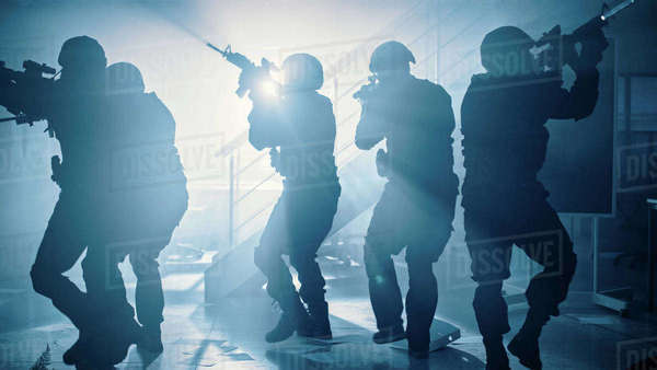 Masked Team of Armed SWAT Police Officers Move in a Hall of a Dark ...
