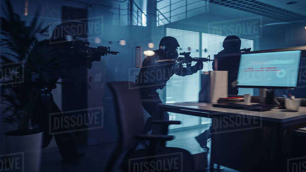 Masked Squad of Armed SWAT Police Officers Move in a Hall of a Dark ...