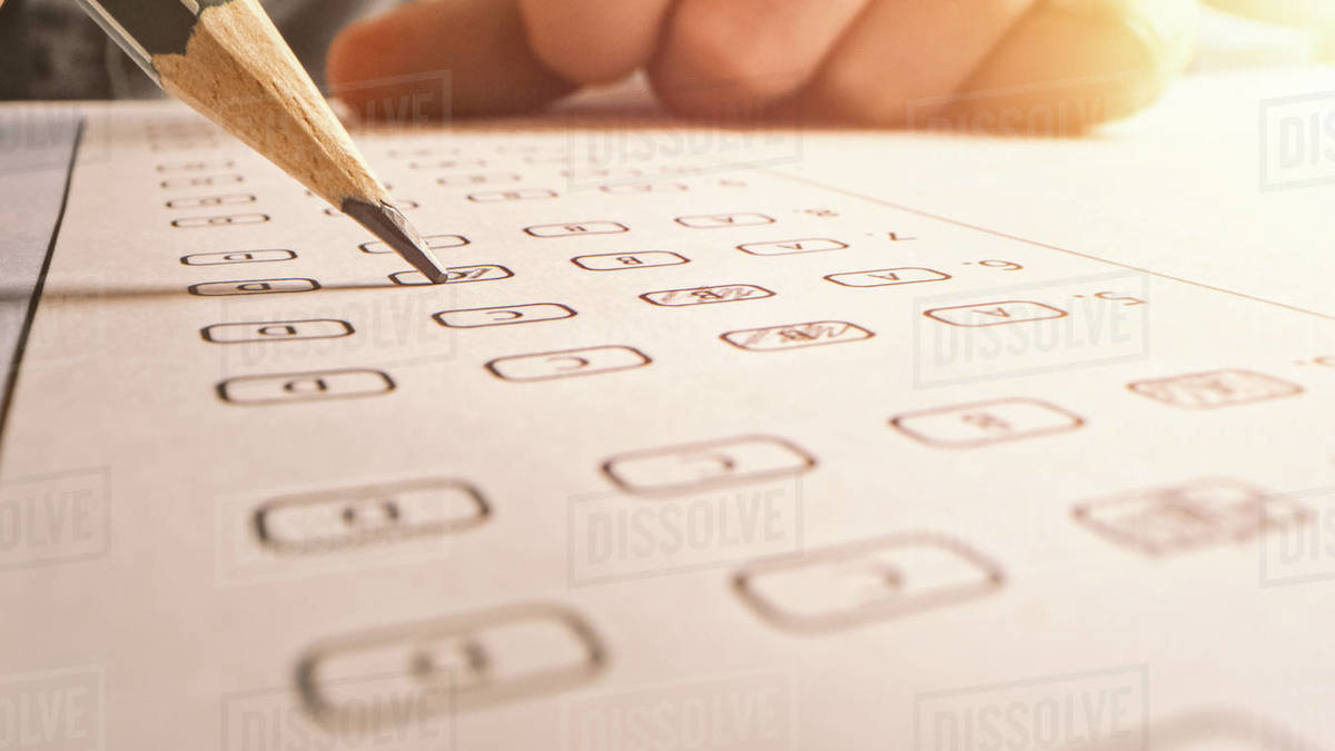 On Exam Test Person Colors Right Answers with a Pencil. Filling up ...