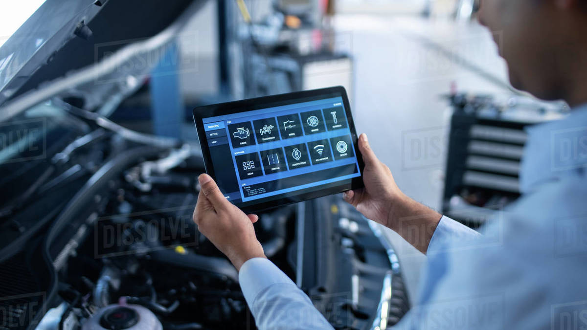 Car Service Manager or Mechanic Uses a Tablet Computer with a ...