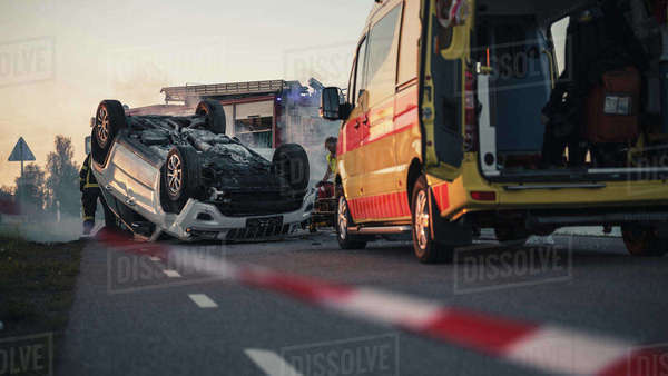 On the Car Crash Traffic Accident Scene Rollover Smoking Vehicle Lying ...