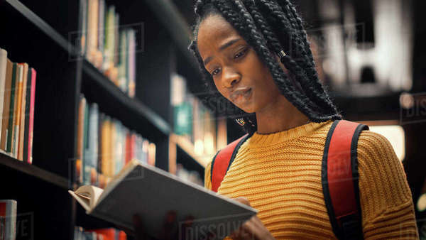 University Library: Smart Beautiful Girl Standing Next to Bookshelf ...
