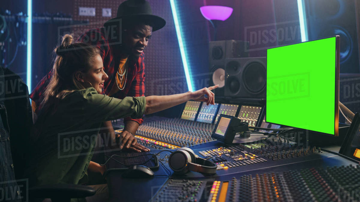 Producer and Audio Engineer Working together in Music Record Studio on ...