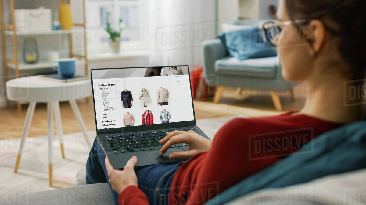 Young Woman at Home Using Laptop Computer for Browsing Through Online ...