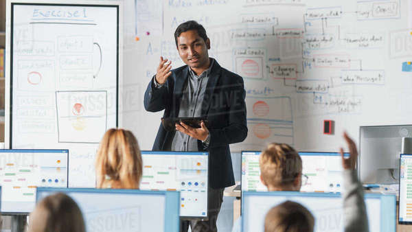 Elementary School Computer Science Class: Teacher Uses Digital Tablet ...