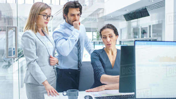 In Bright Modern Office: Office Worker Sitting and Working at Her ...