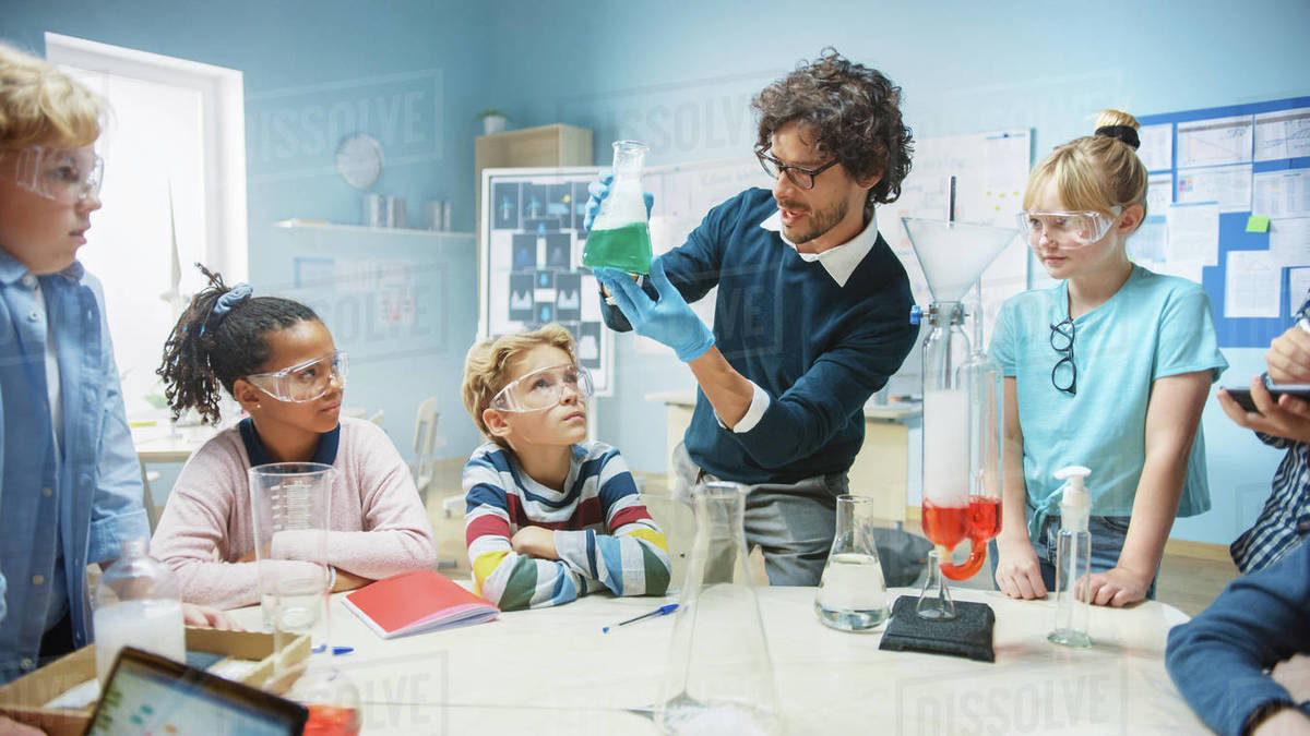 Elementary School Science / Chemistry Classroom: Teacher Shows Chemical ...
