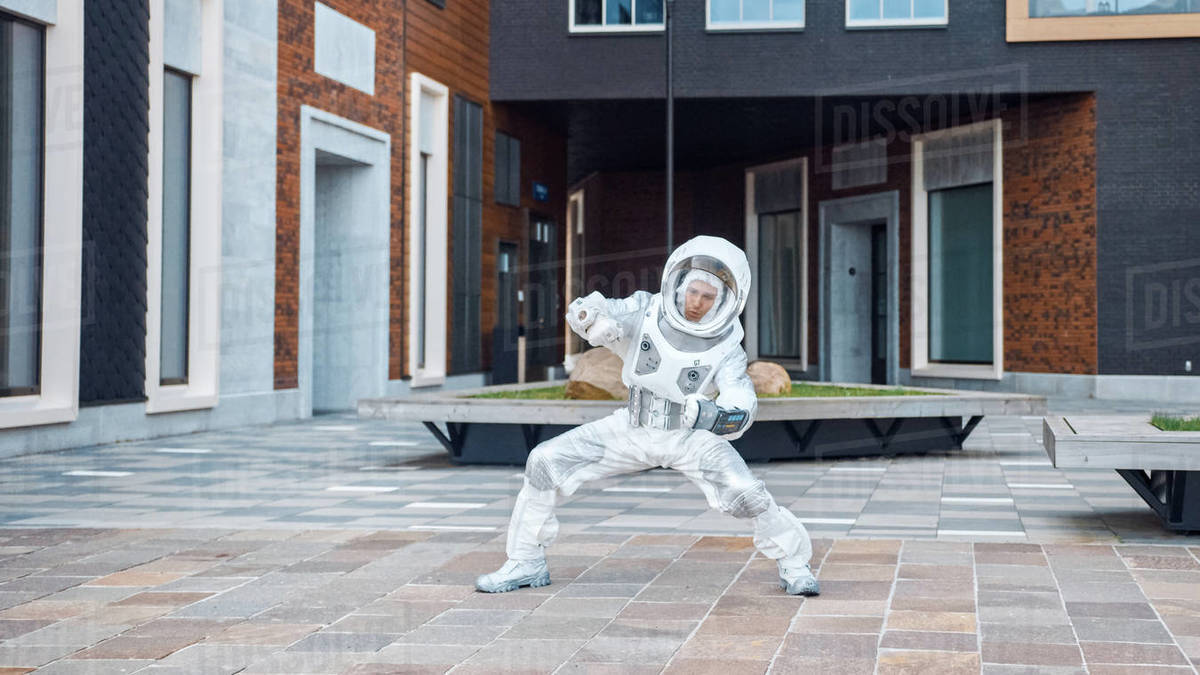 Handsome Man in Spacesuit is Dancing in a Neighbourhood. Astronaut is ...