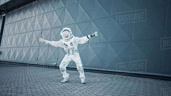 Handsome Man in Spacesuit is Dancing Next to Metal Wall. Astronaut is ...