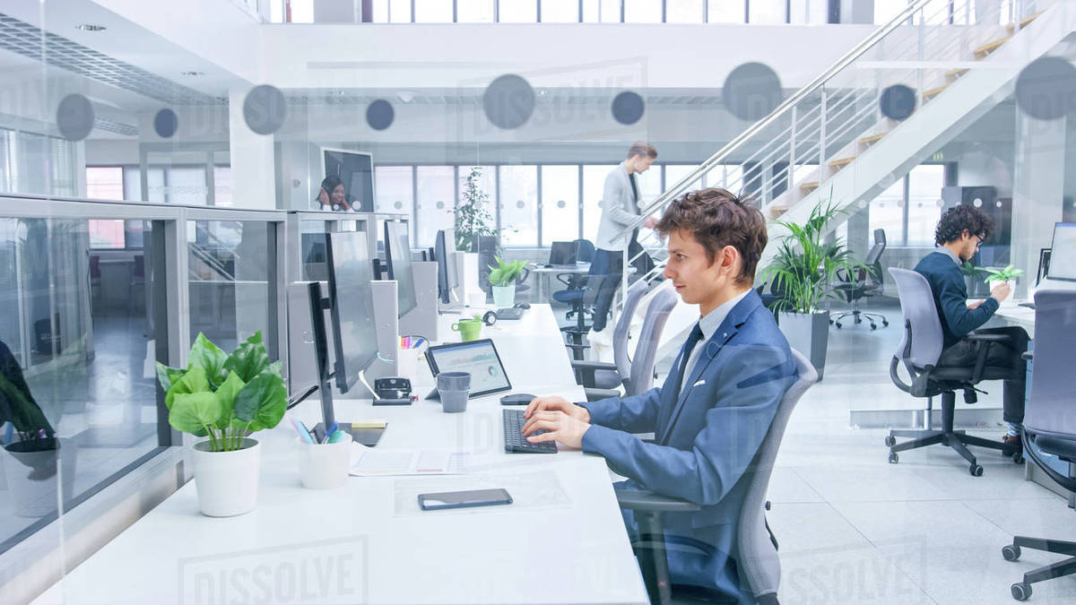 Young Handsome Manager Wearing a Suit and Tie Discusses Work on His ...