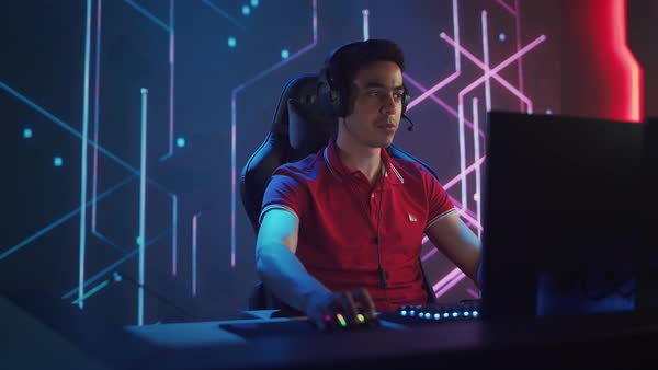 Professional eSports Gamer Playing in Computer Video Games. Background ...