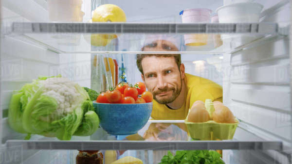 Inside Kitchen Fridge: Young Disappointed Man Looks inside the Fridge ...