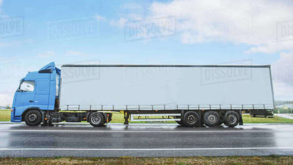 Side View Shot of a Blue Long Haul Semi-Truck with Cargo Trailer ...