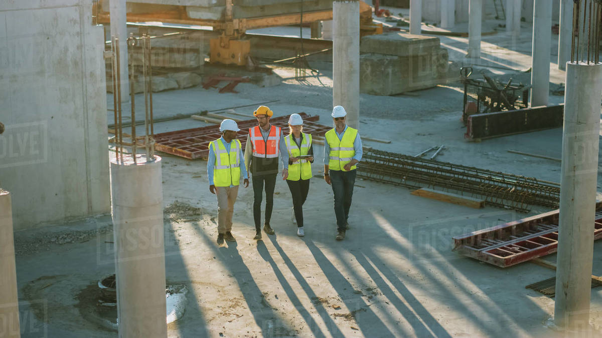 Diverse Team of Specialists Taking a Walk Through Construction Site ...