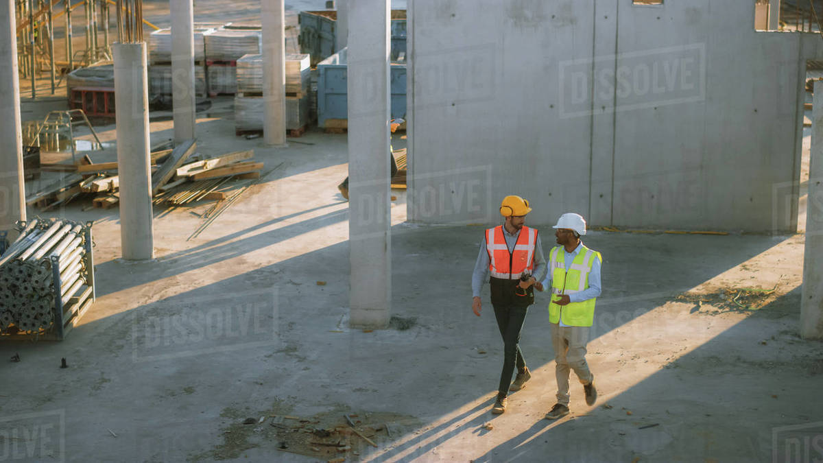 Two Multicultural General Contractors Taking a Walk Through ...
