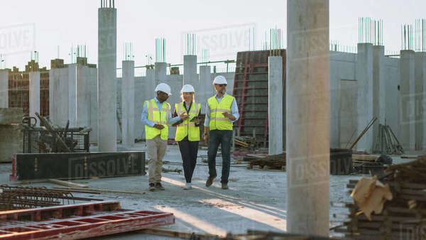 Diverse Team of Specialists Taking a Walk Through Construction Site ...