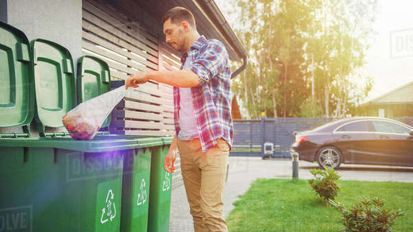 Man throwing away trash next to his house - Royalty-free Stock Photo ...