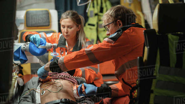 Paramedic Providing Medical Help to Injured Patient on the Way to ...