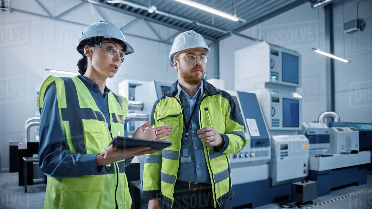 Project Manager and Male Engineer Standing Wearing Safety Jackets ...