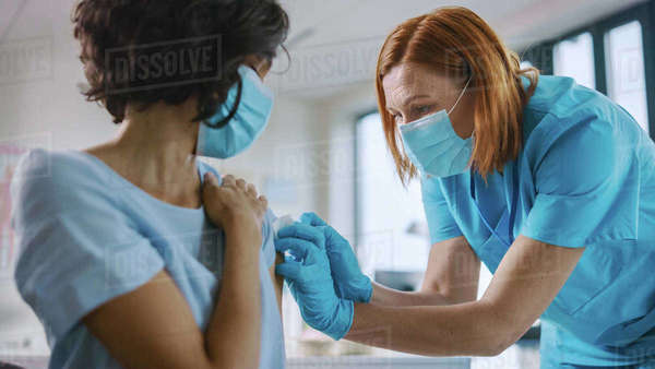 Medical Nurse Injecting Vaccine to a Patient in a Health Clinic ...