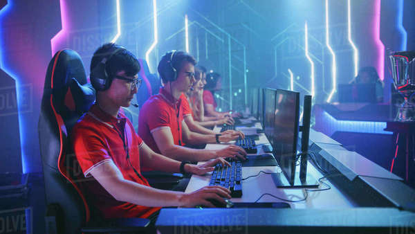 Shot of a Concentrated Esport Team of Pro Gamers Play in Video Game on ...
