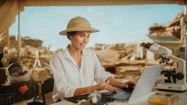 Female Archaeologist Doing Research - Stock Photo - Dissolve