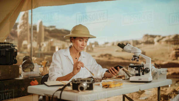 Female Archaeologist Doing Research - Royalty-free Stock Photo | Dissolve