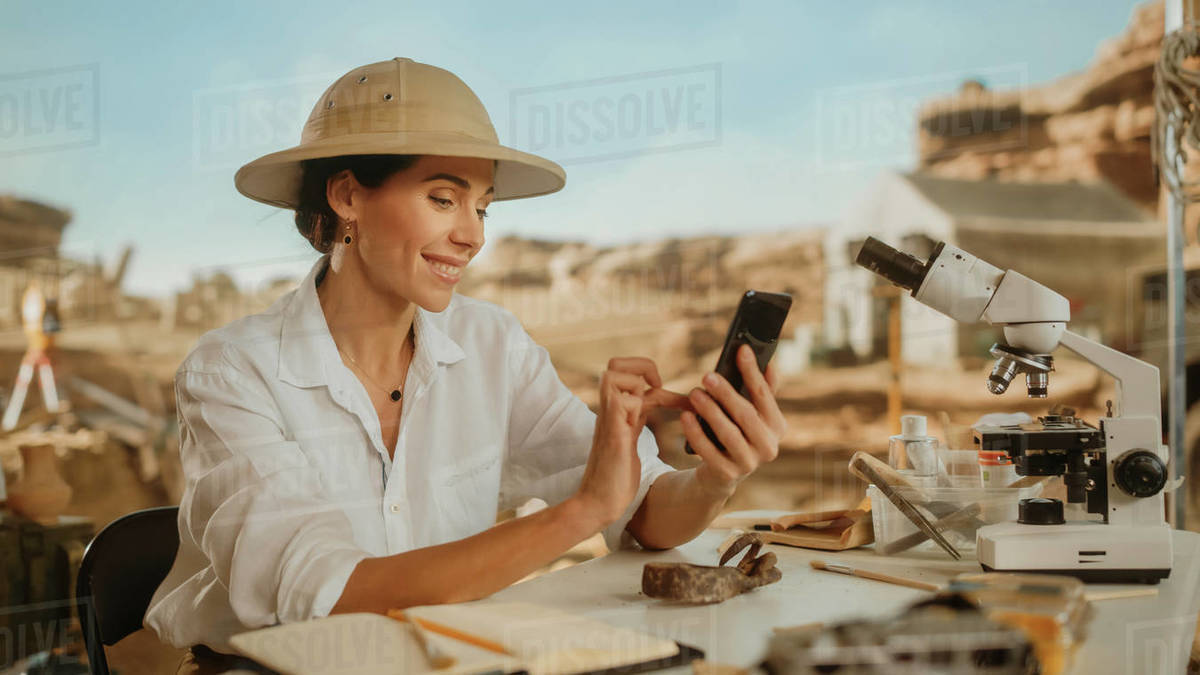 Female Archaeologist Doing Research - Stock Photo - Dissolve